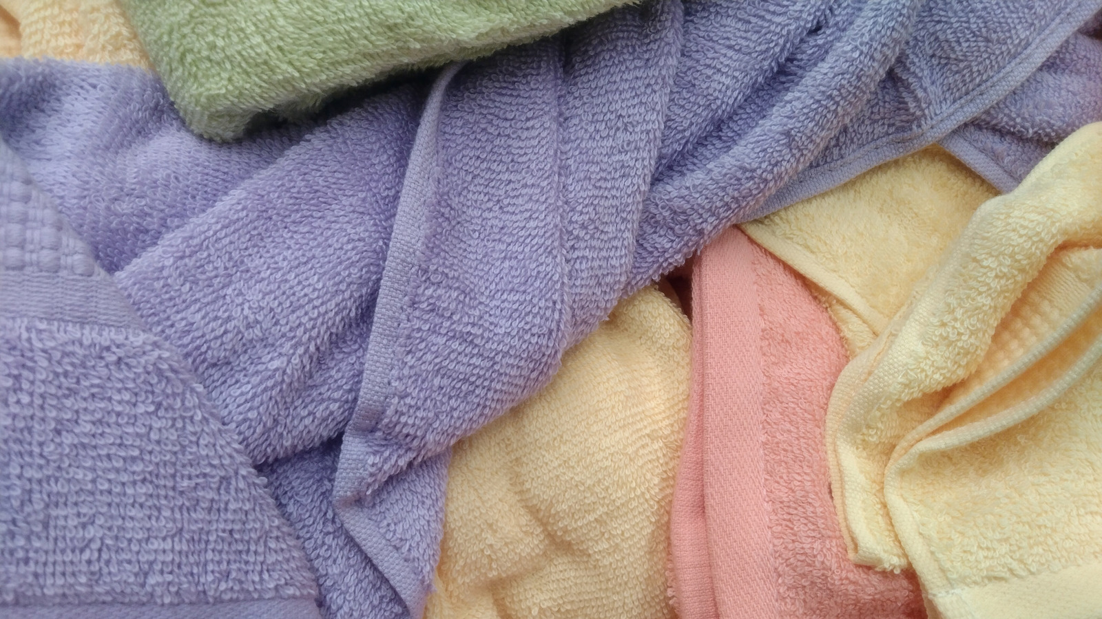 Create Extra Towel Storage Space With A Simple Tension Rod Hack