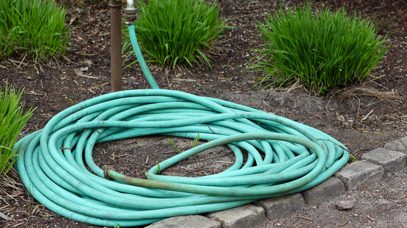 Use A Plastic Bottle To Keep Garden Hoses Neat & Organized
